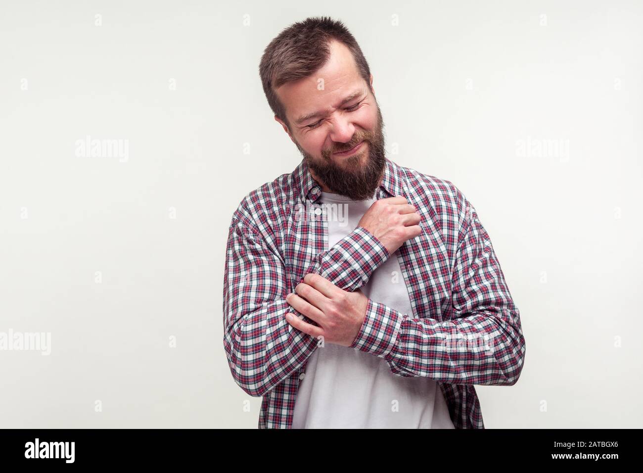 Hand damage, injury. Portrait of unhealthy bearded man in casual plaid ...