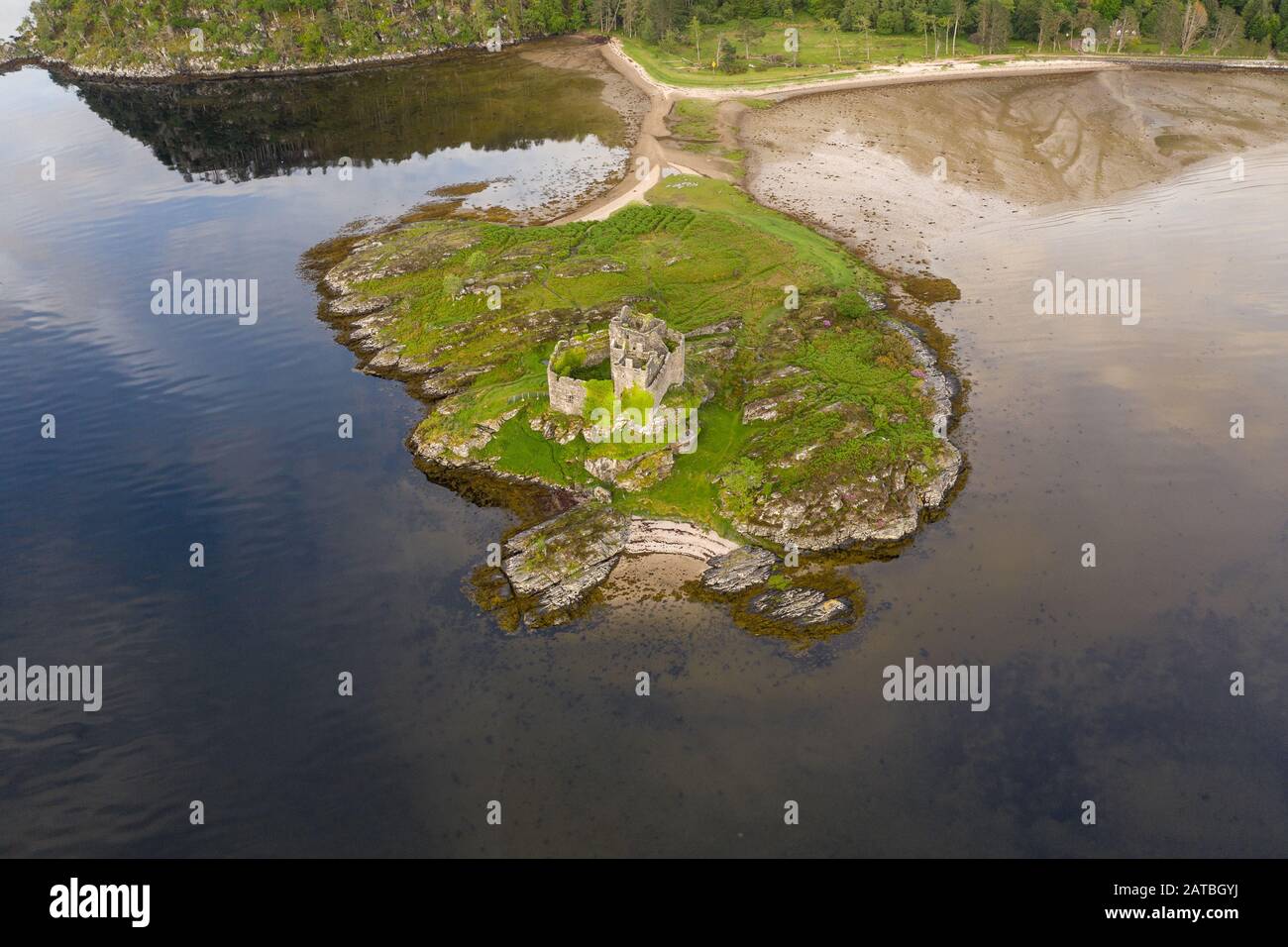 Aerial drone shot of Castle Tioram, it is a ruined castle that sits on ...