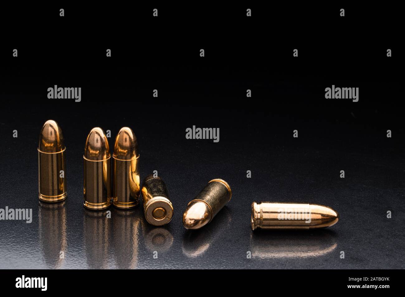 Bullet isolated on black background with reflexion. Rifle bullets close ...