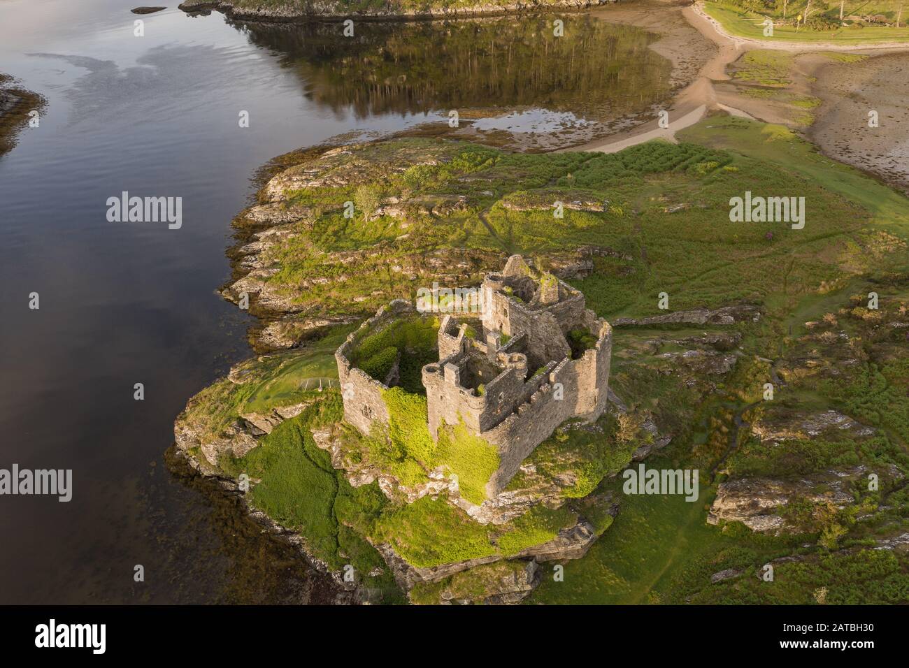 Aerial drone shot of Castle Tioram, it is a ruined castle that sits on ...