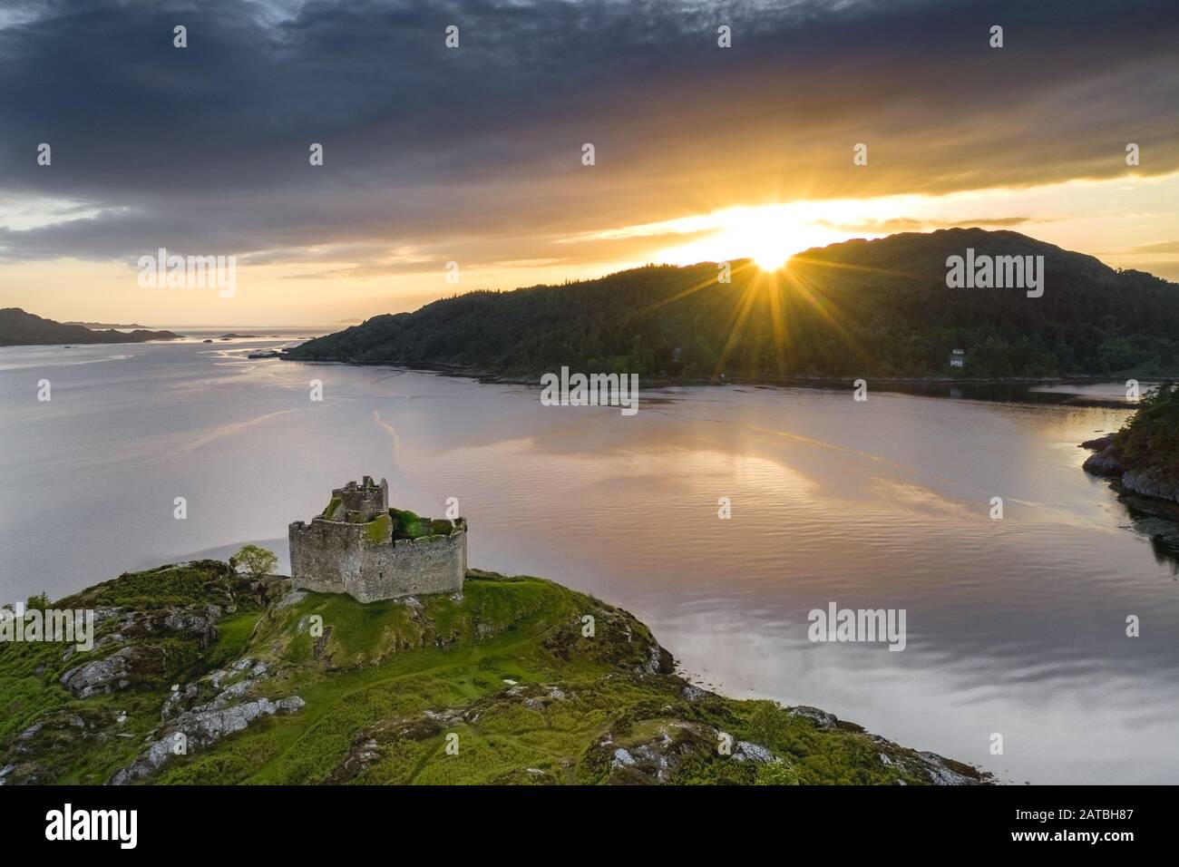 Aerial drone shot of Castle Tioram, it is a ruined castle that sits on ...