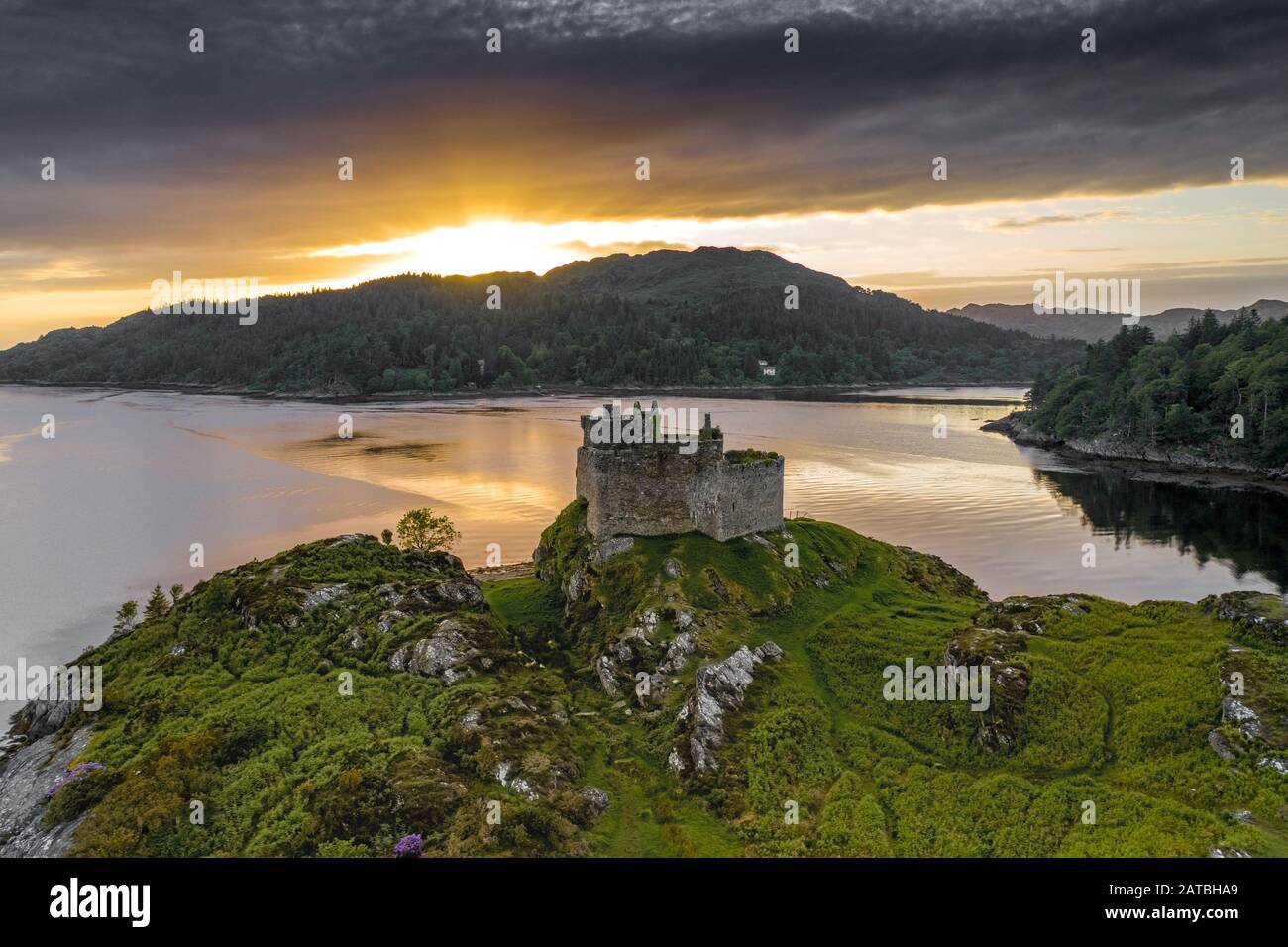 Aerial drone shot of Castle Tioram, it is a ruined castle that sits on ...