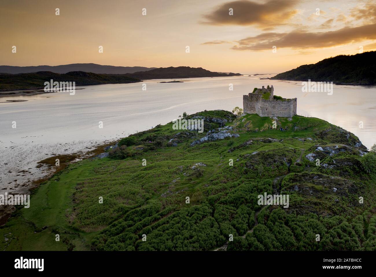 Aerial drone shot of Castle Tioram, it is a ruined castle that sits on ...