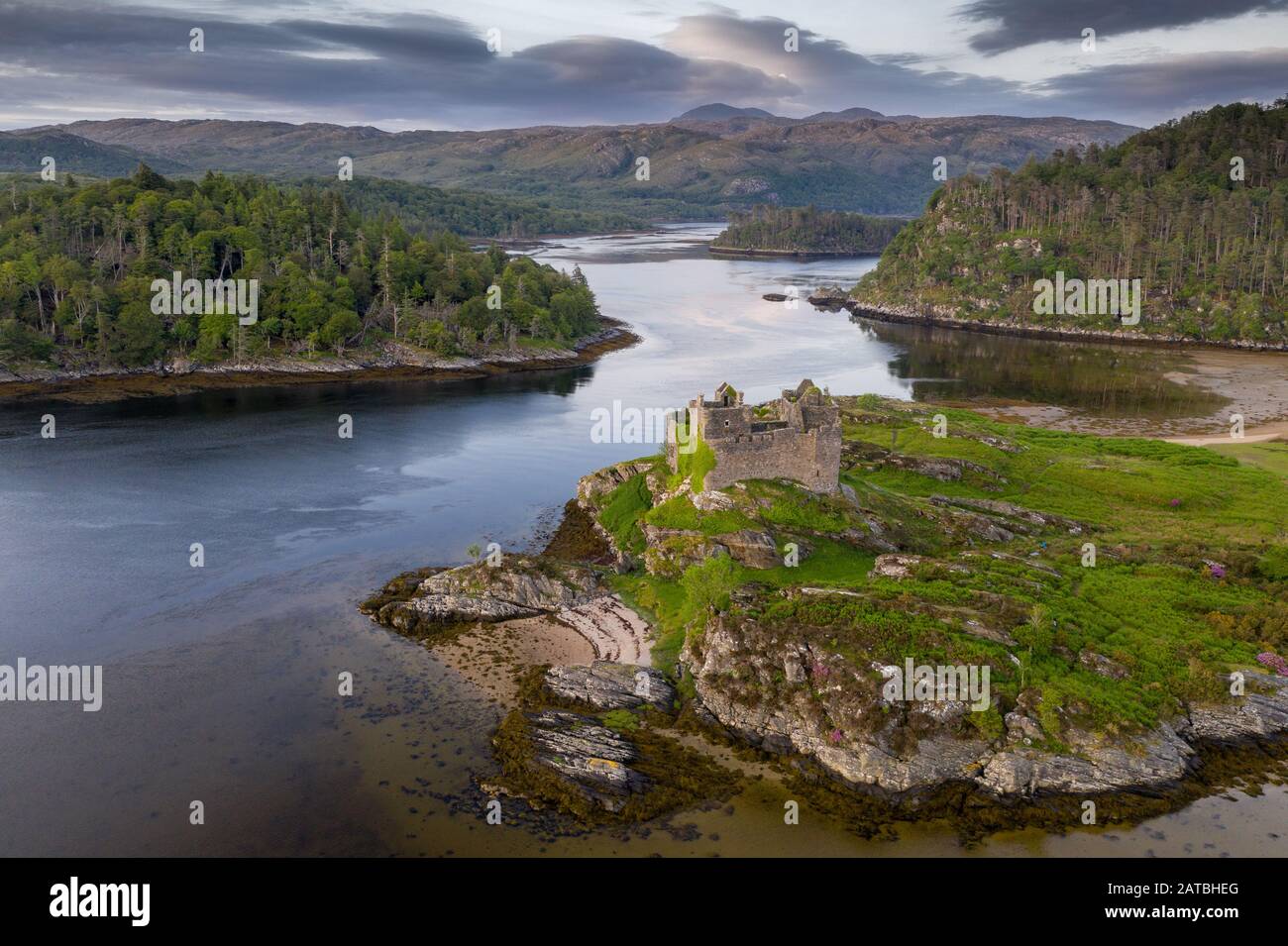 Aerial drone shot of Castle Tioram, it is a ruined castle that sits on ...