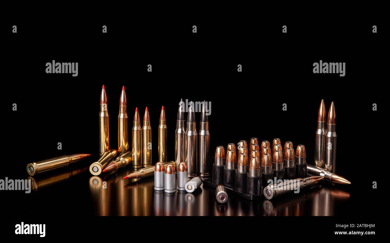 Bullet isolated on black background with reflexion. Rifle bullets close ...
