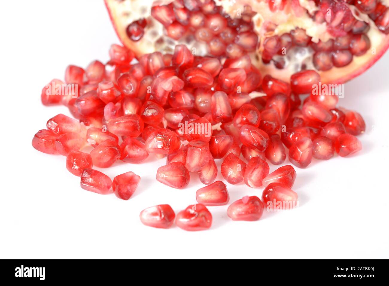 Organic pomegranate seeds on white Stock Photo - Alamy