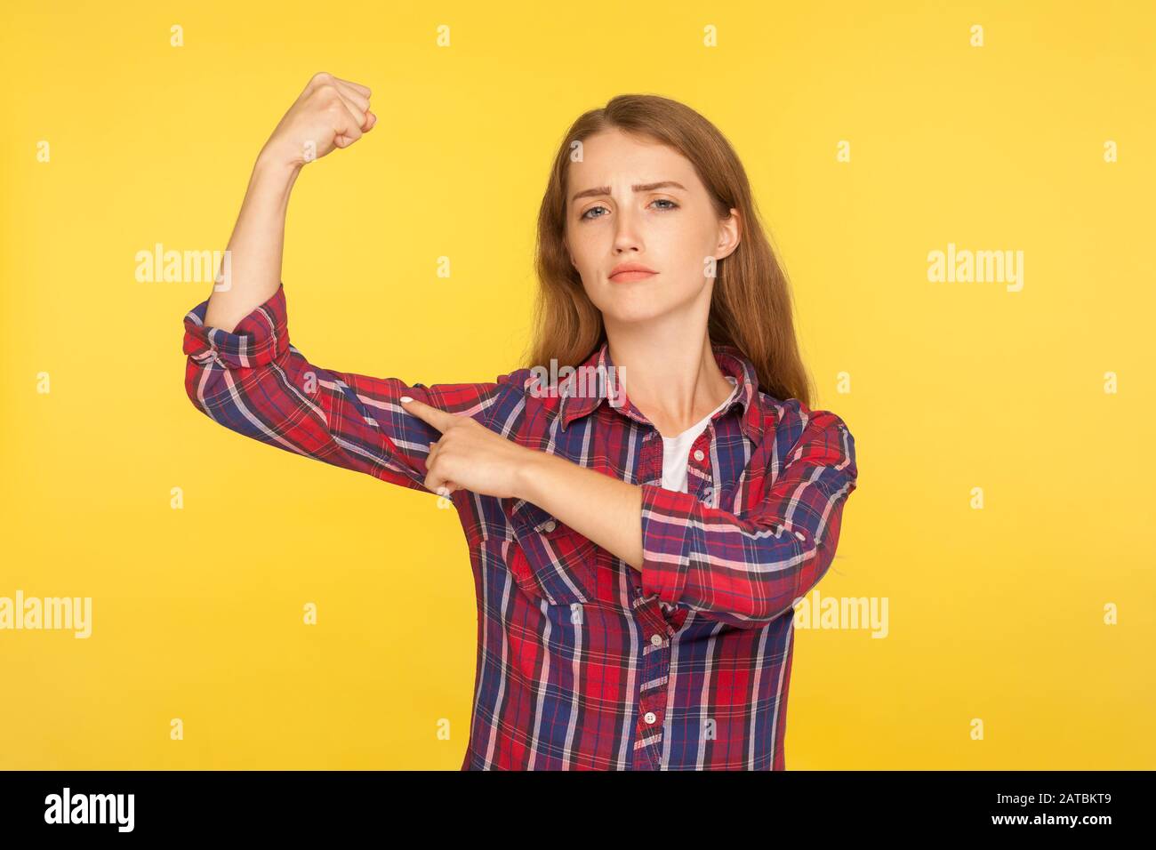 Look, I'm strong woman! Portrait of self-confident ginger girl in ...