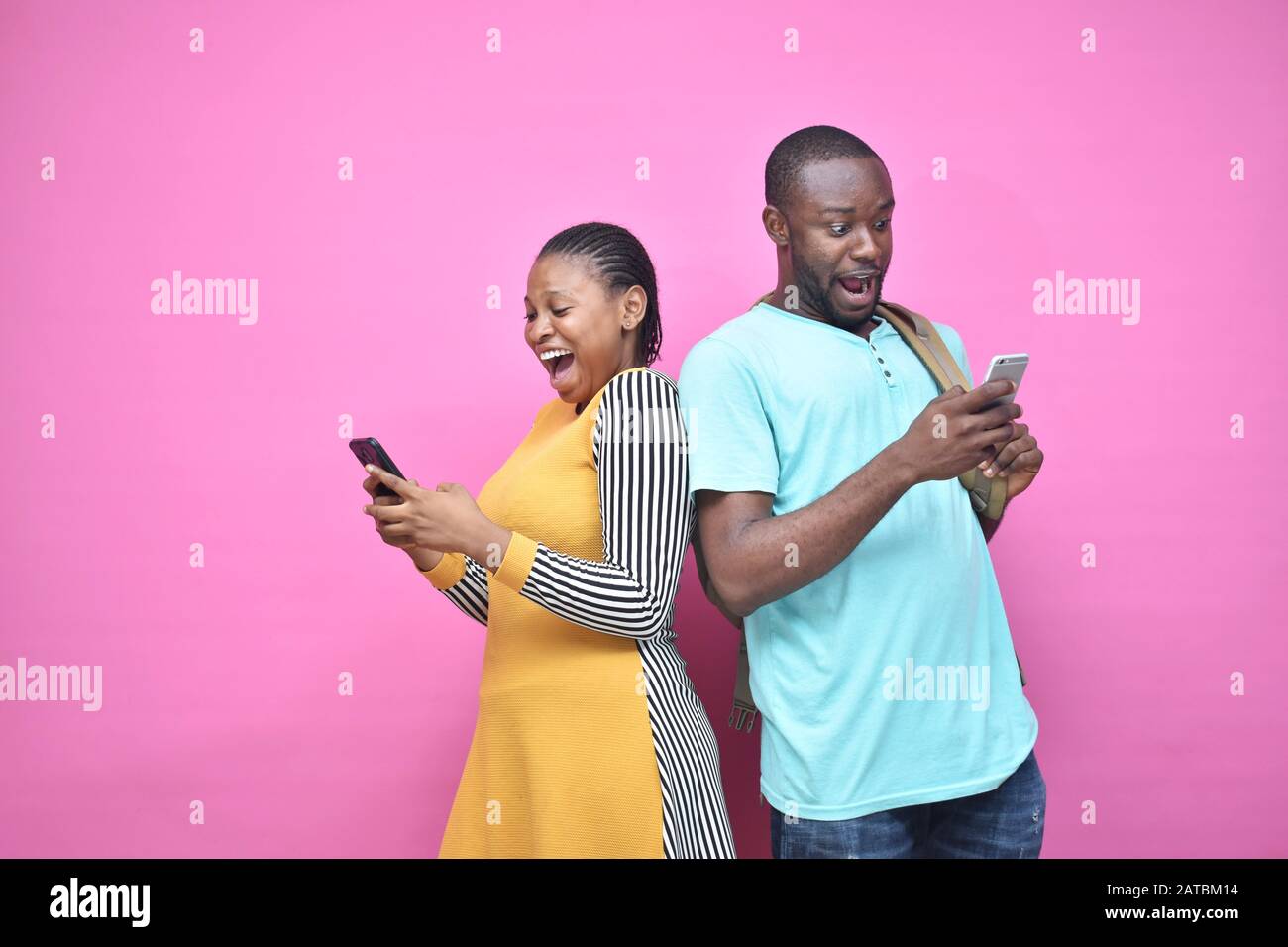 excited young black people standing back to back viewing contents on ...