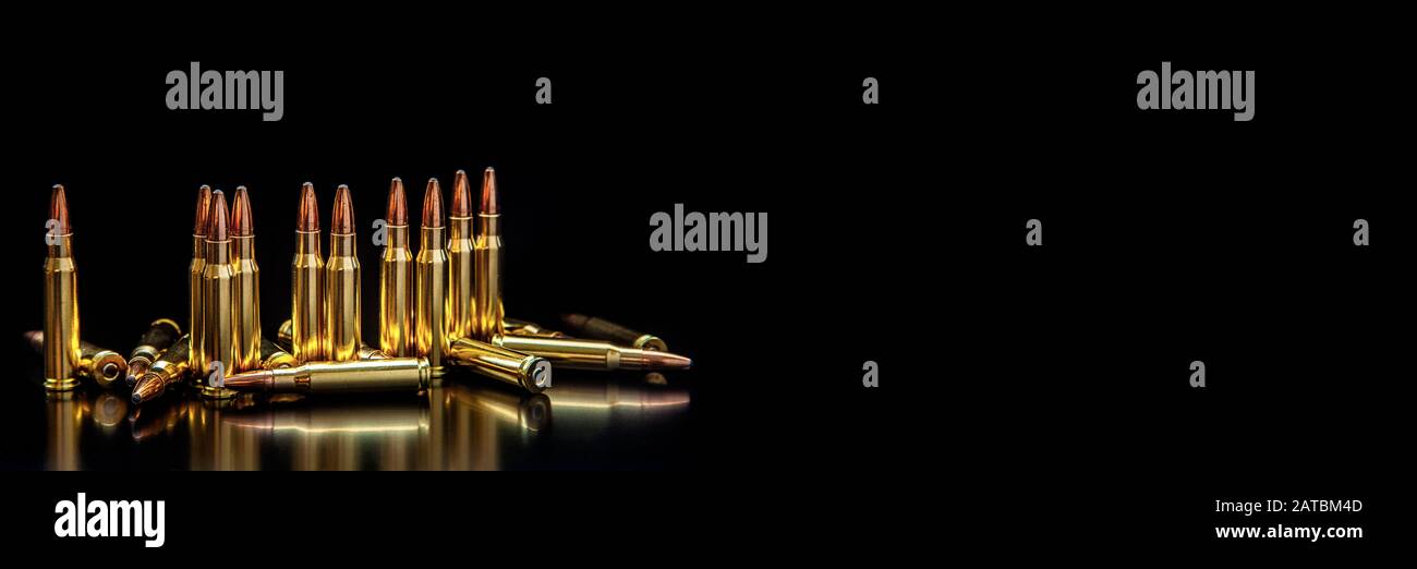 Bullet isolated on black background with reflexion. Rifle bullets close ...