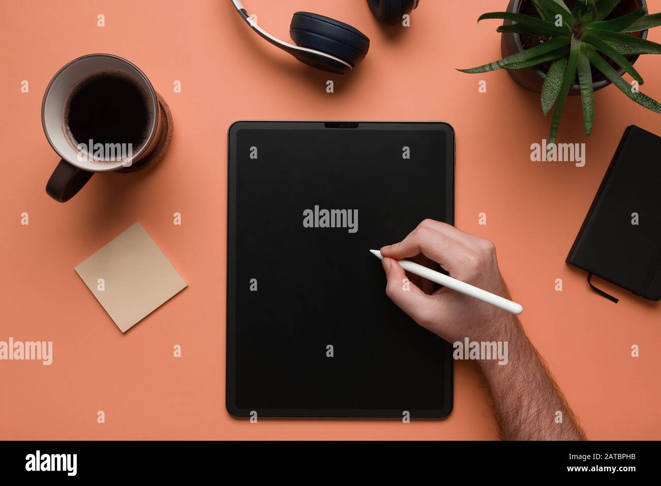 Stock photo of a young man's hand writing on the screen of a black ...