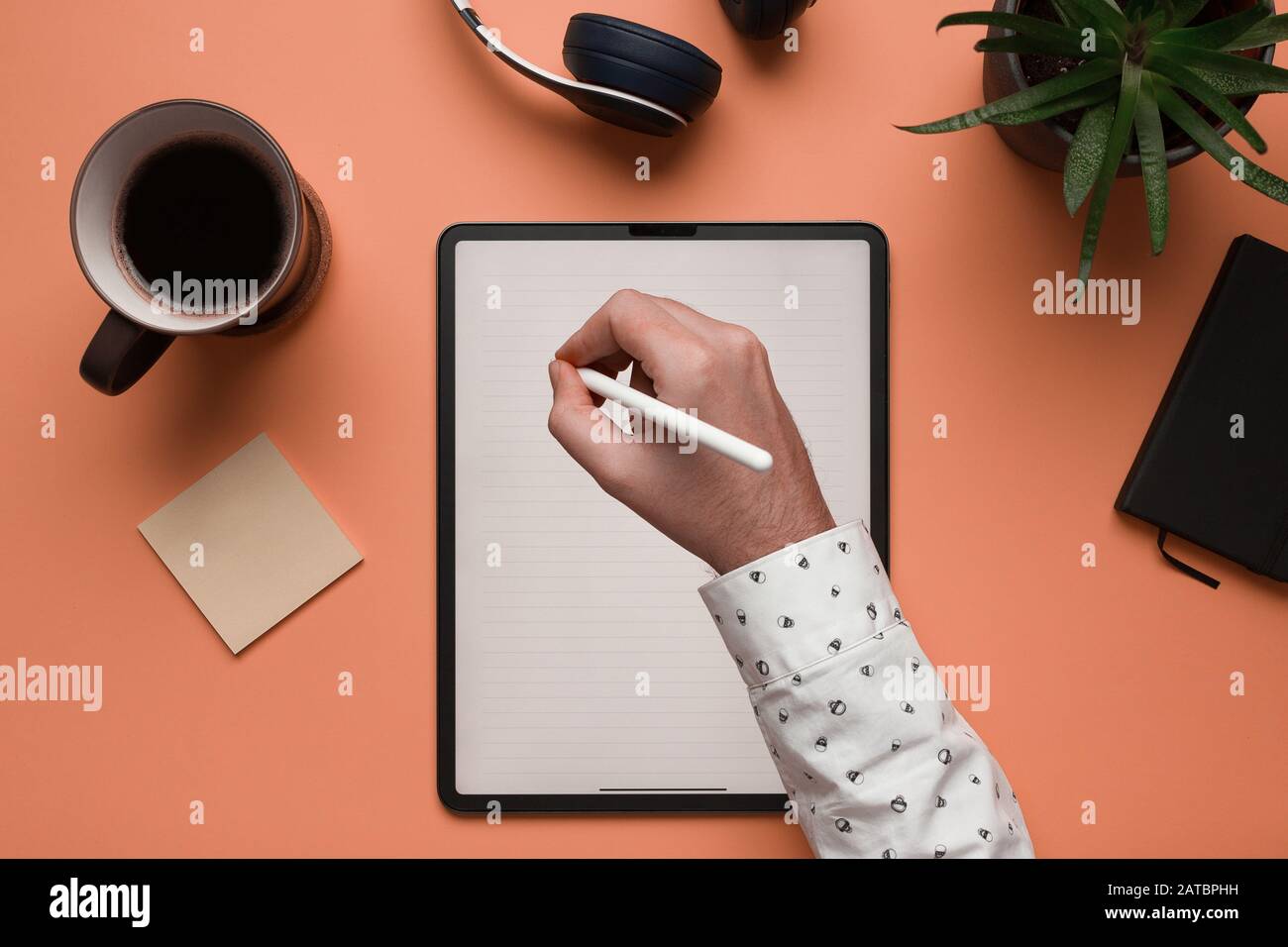 Stock photo of a young man's hand writing notes on the screen of a ...