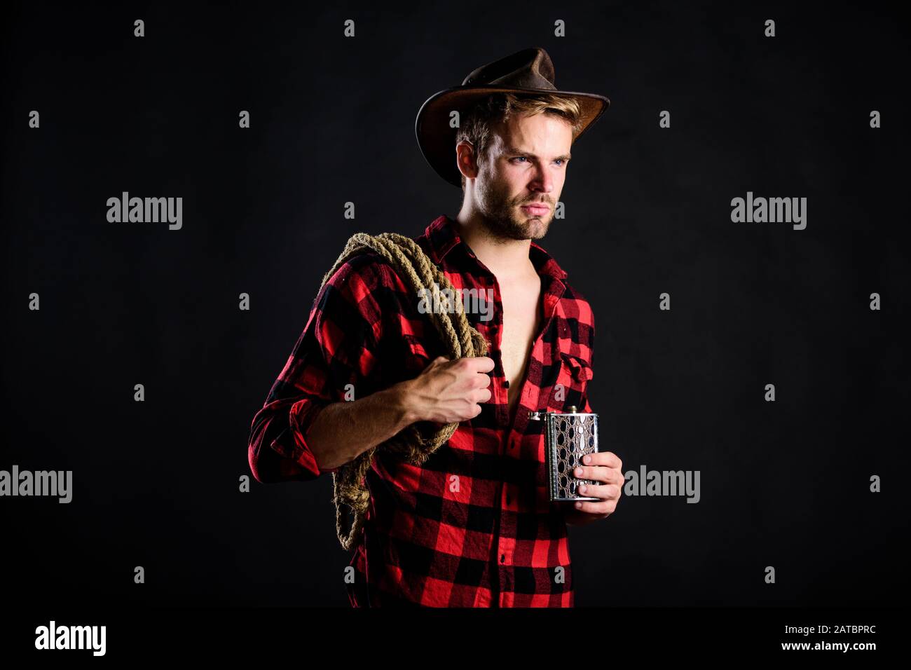 Sheriff concept. Brutal cowboy drinking alcohol. Western culture. Man ...