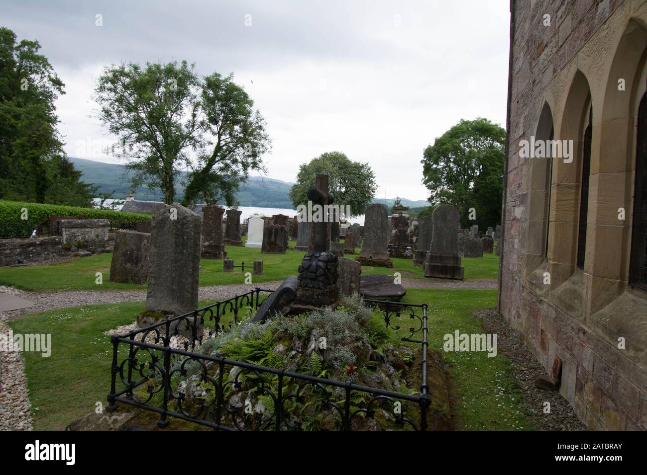 Church and graves Luss Scotland cemetery railings metal arch arched ...