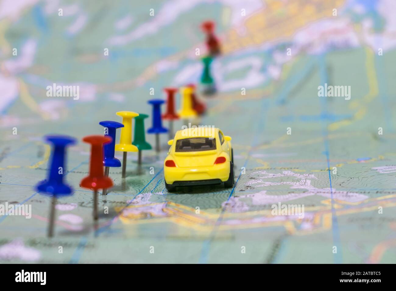The yellow car travels along the geographic map along the route of the ...