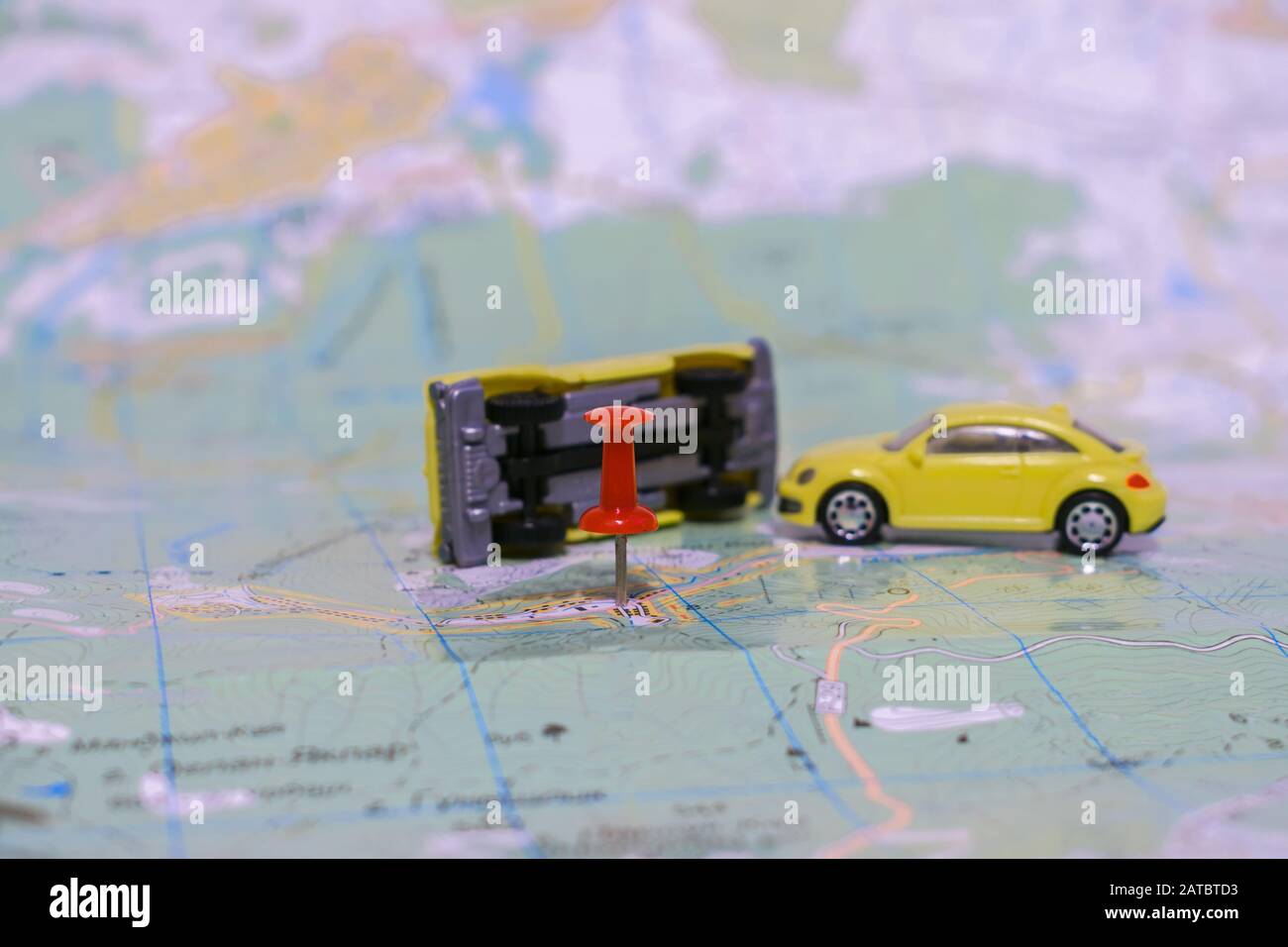 Two toy cars collided on the geographical map of the world. Accident of ...