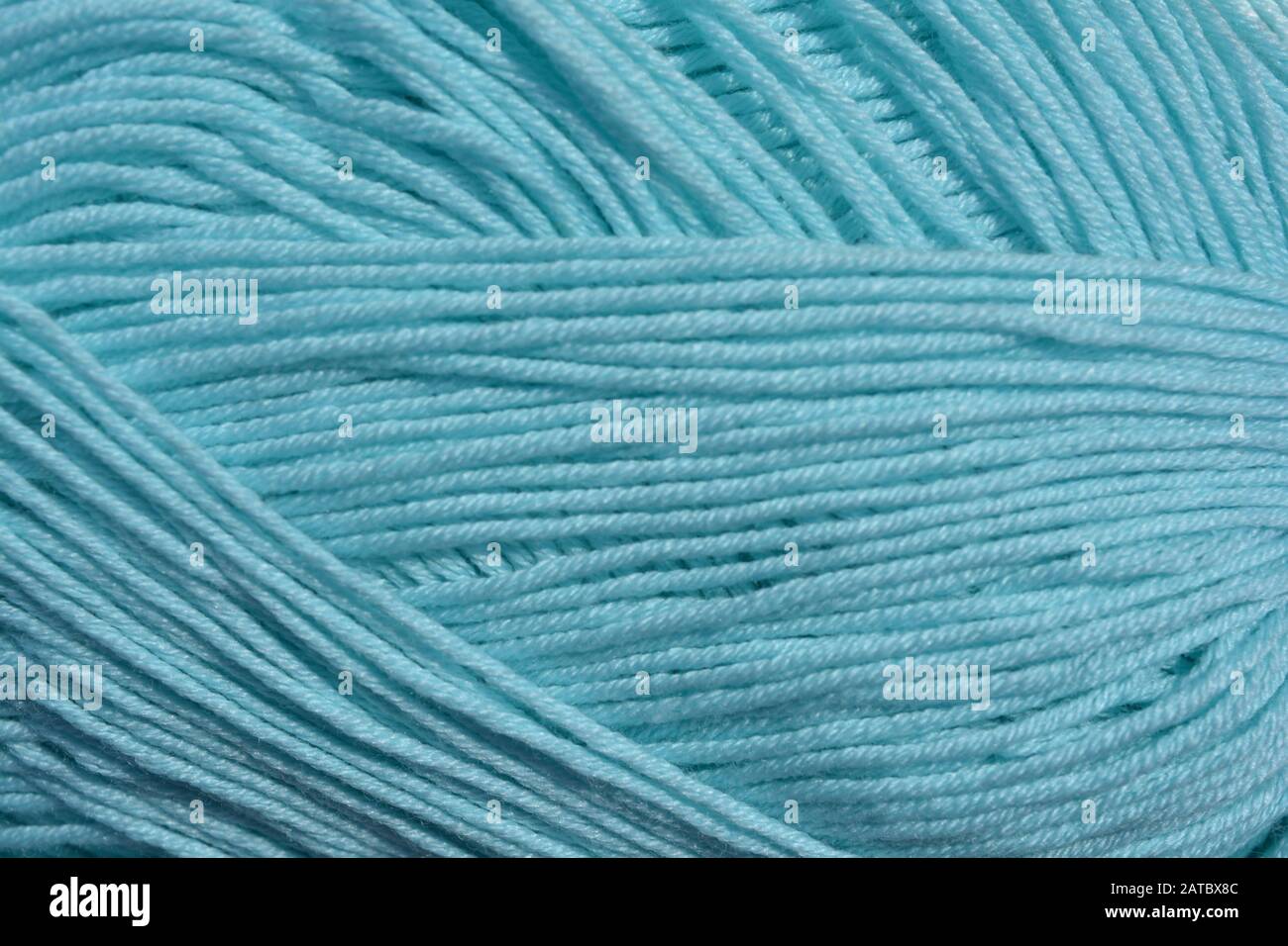 Closeup of a ball of natural organic azure wool forming a wavy pattern ...