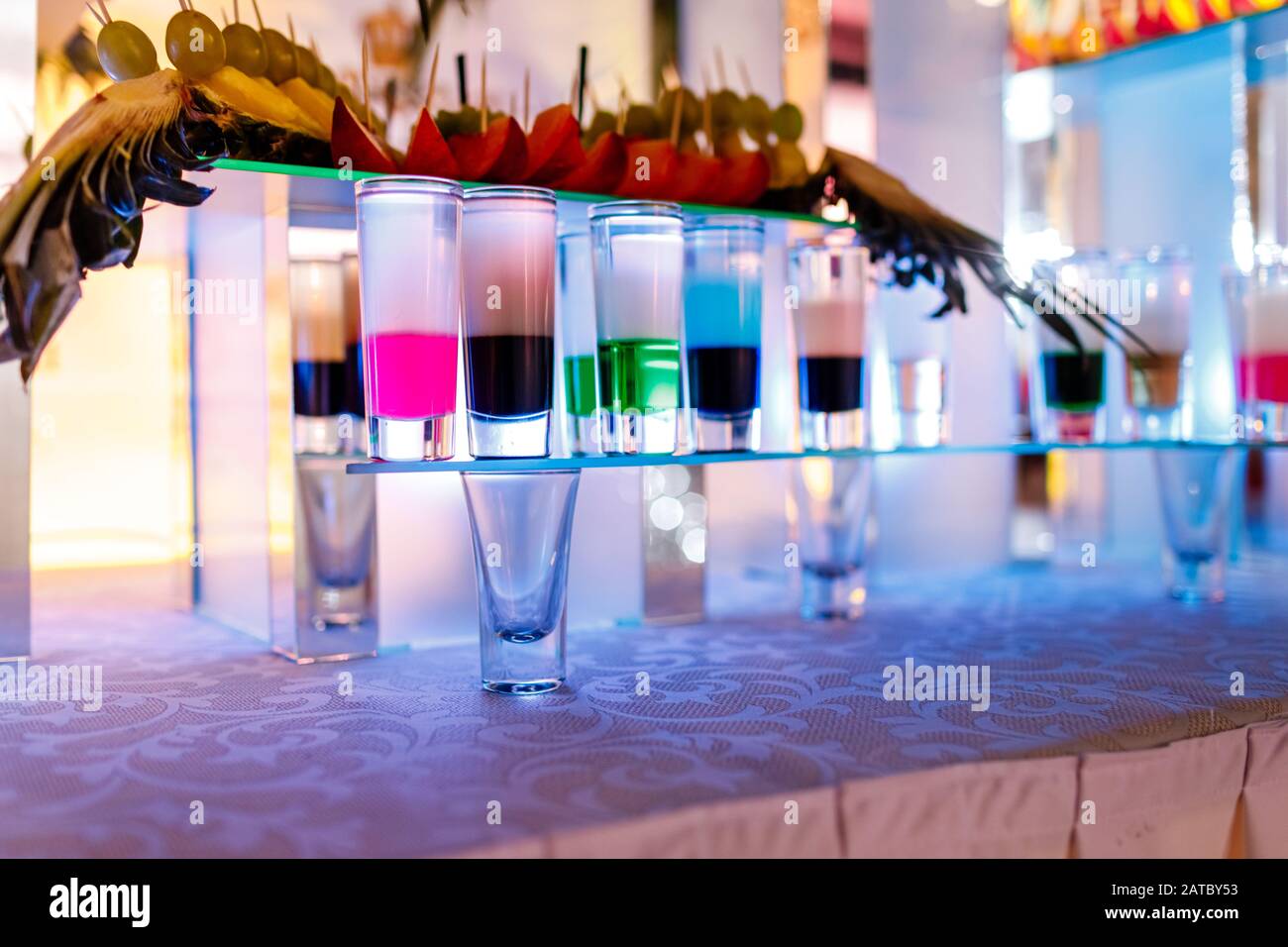 collection of colorful shots with fruits on bar. set of alcohol mini ...