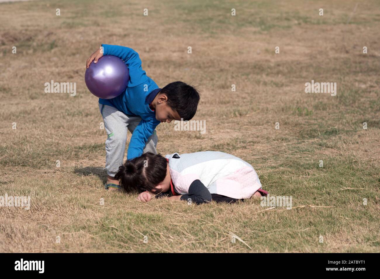 Little girl hiding her face in the ground Stock Photo - Alamy