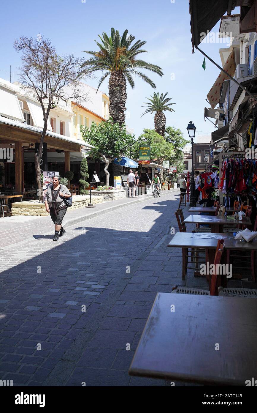 Holidaymakers and locals walking in old town Rethymnon on a very warm ...