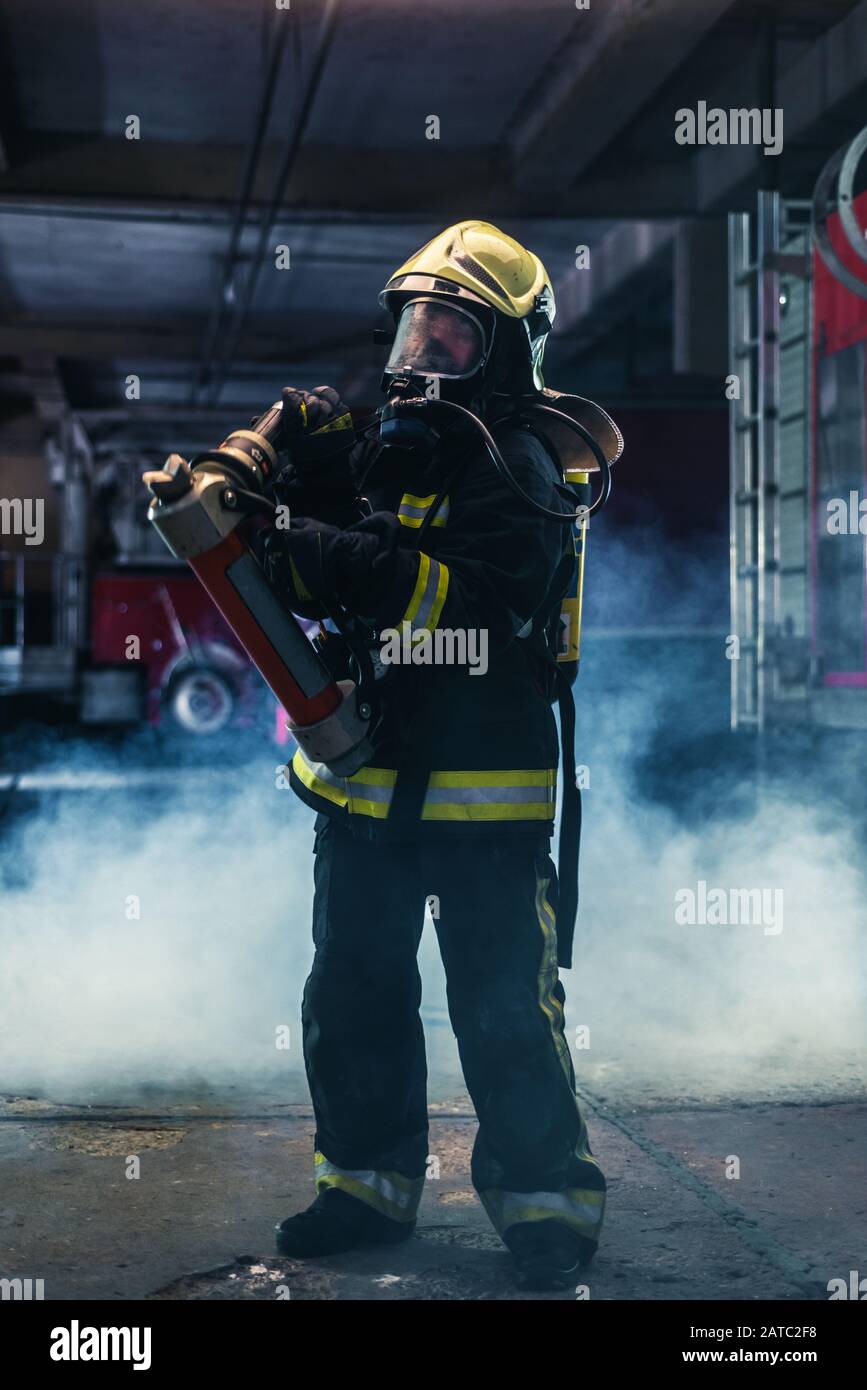 Portrait of a female firefighter wearing a helmet and all safety ...