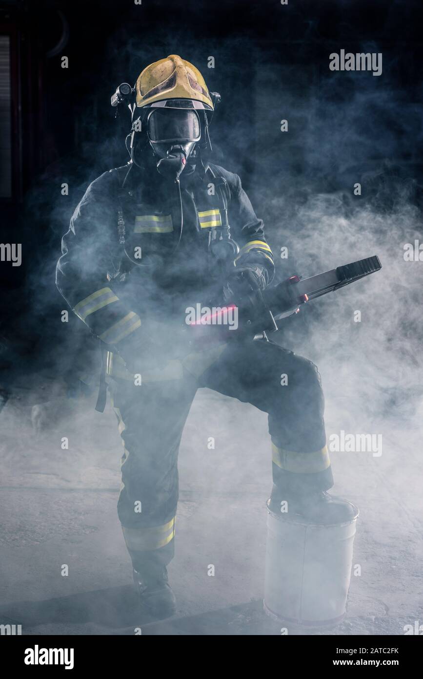 Portrait of a brave firefighter standing confident wearing full ...