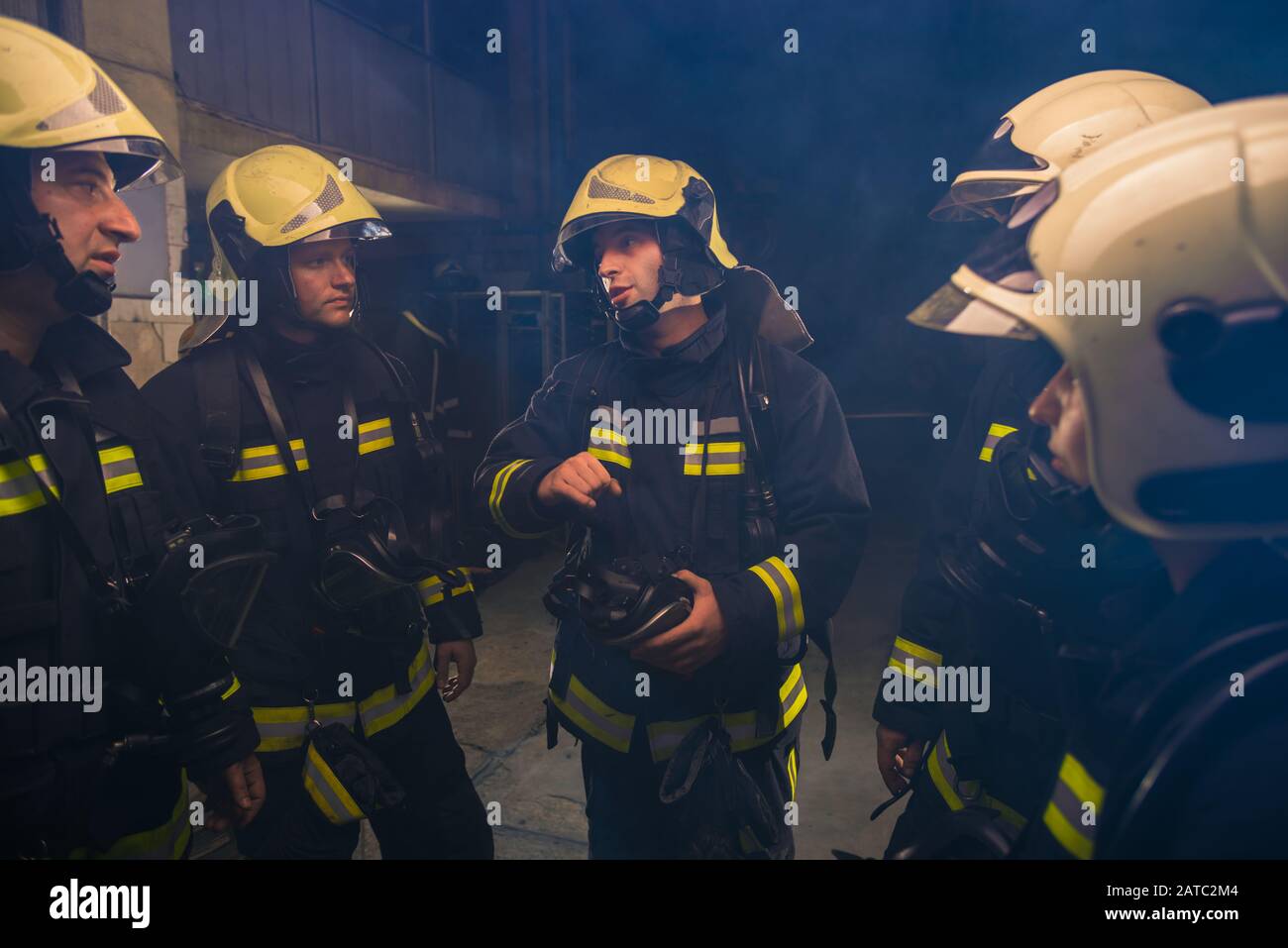 Group of firemen in the fire department organizing action plan for safe ...