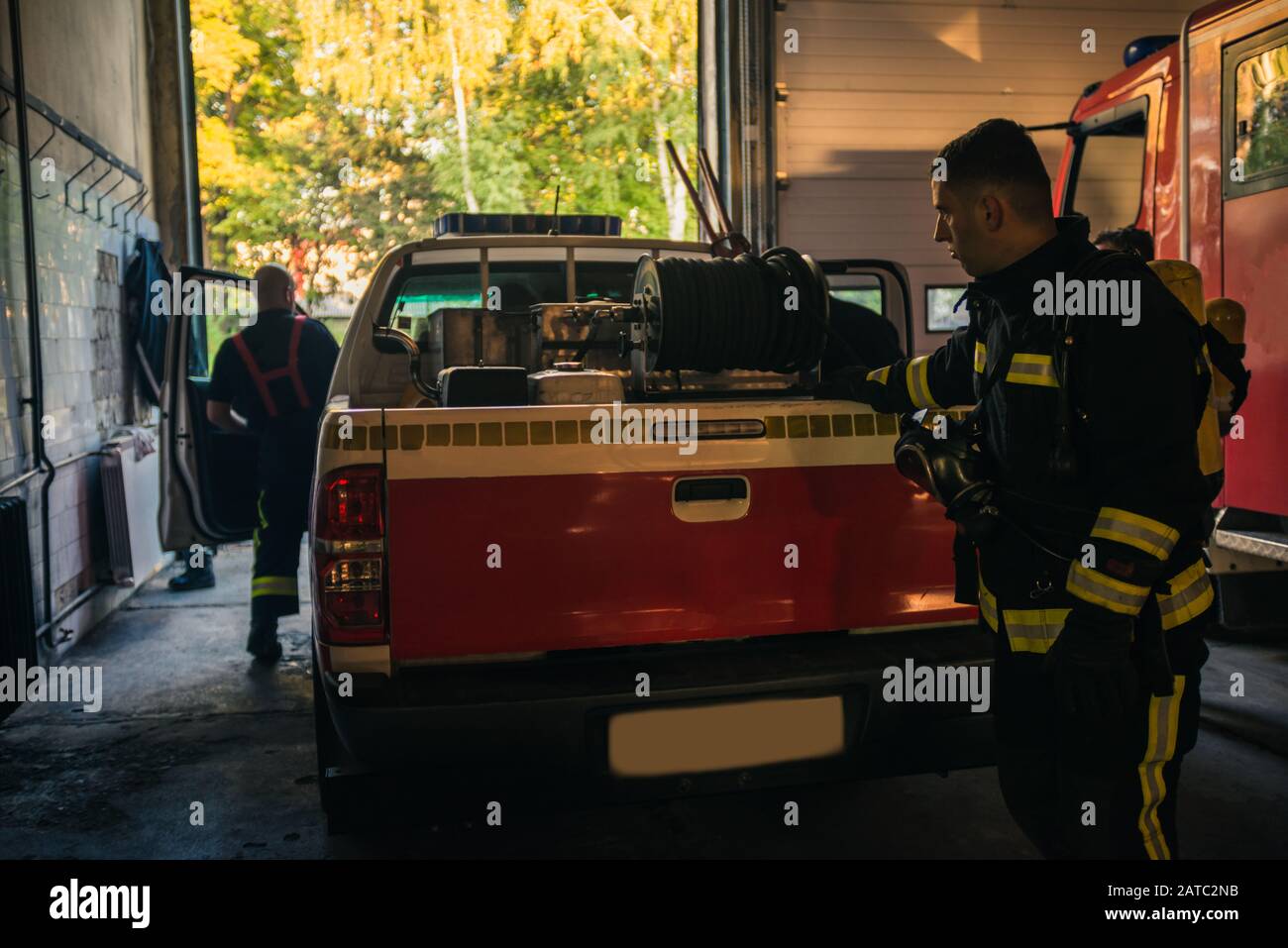Fire engine truck parked inside the garage of the fire department Stock ...