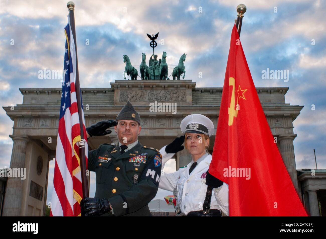 Actors dressed in American and East German military uniform posing for ...