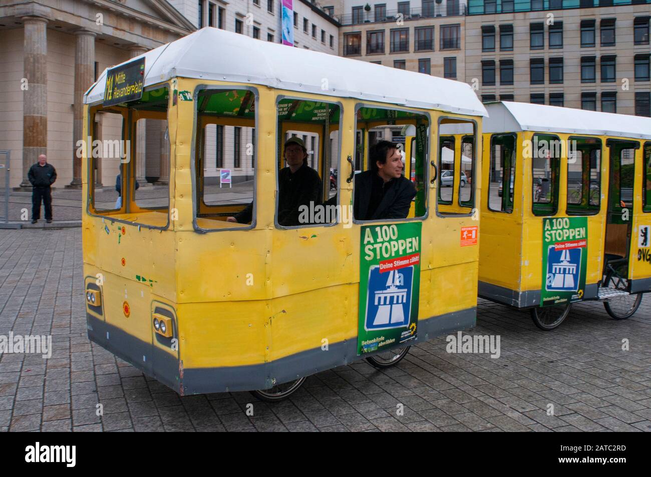 People ride a tandem cycle disguised as a local M4 tram at the 40th ...