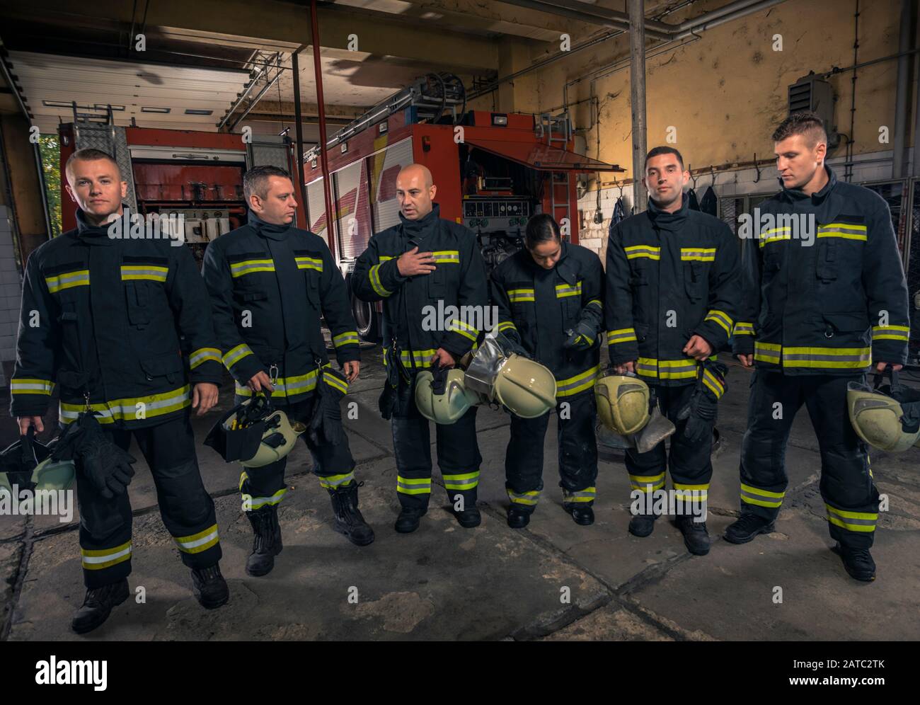 Portrait of firefighters standing by a fire engine Stock Photo - Alamy