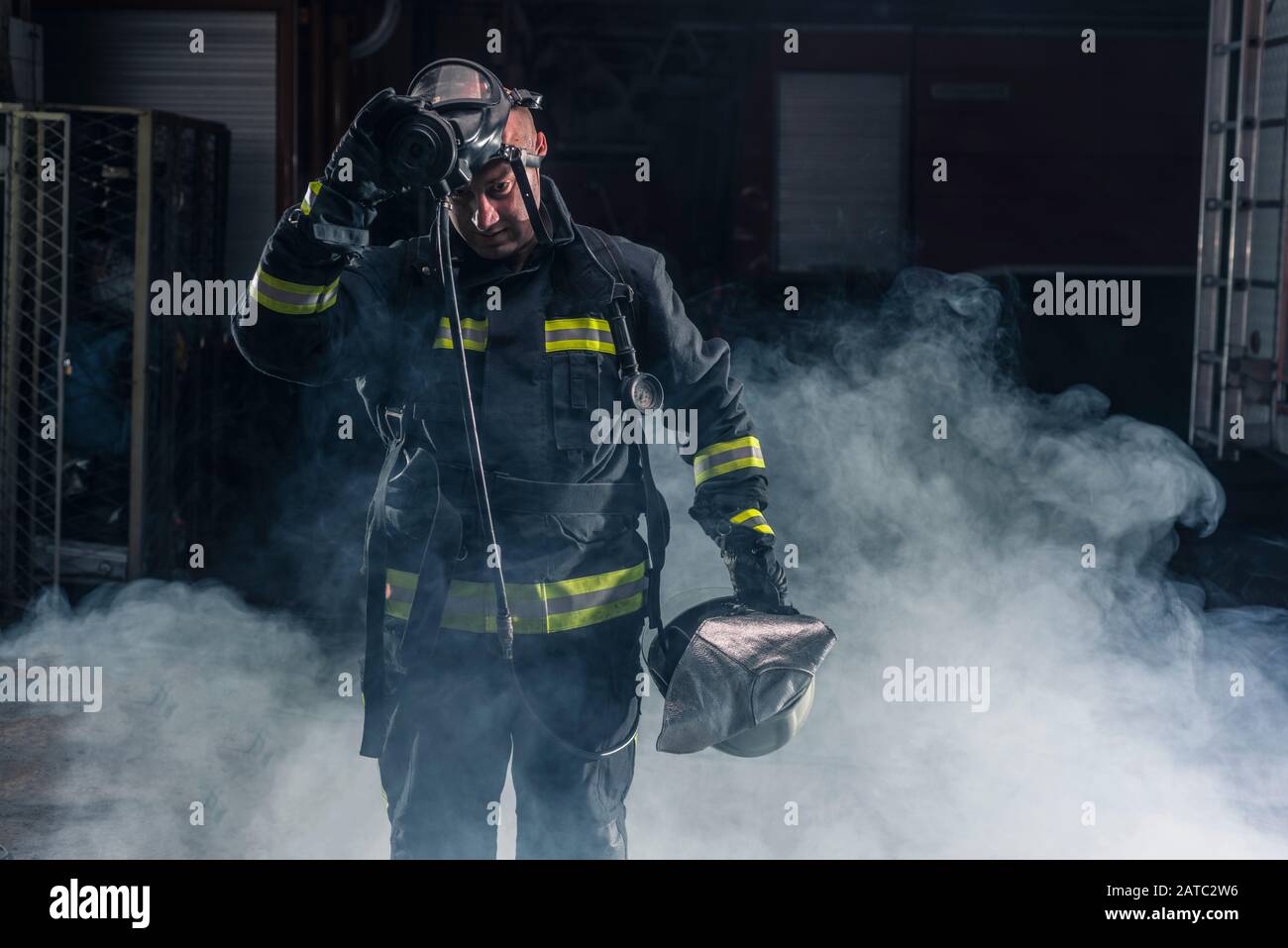 Fireman standing confident holding helmet and wearing firefighter ...