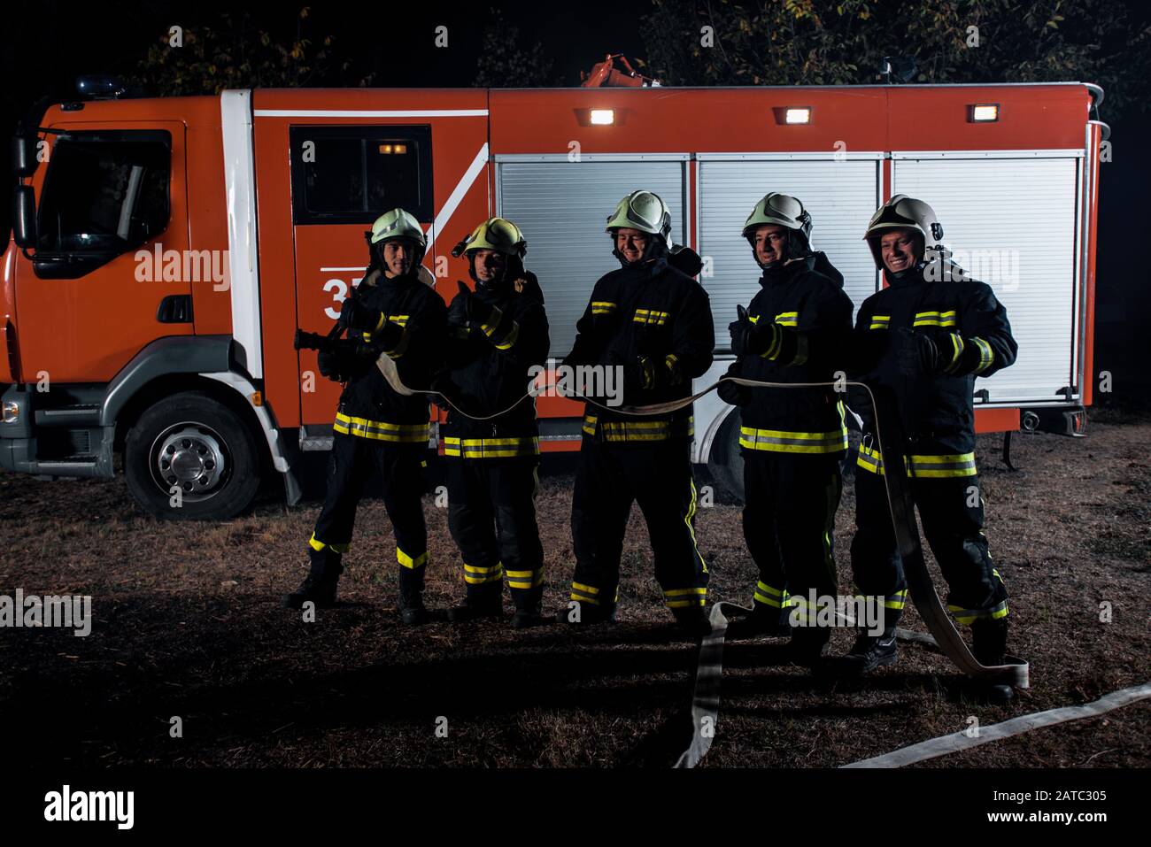 Firemen getting ready during a firefighting intervention Stock Photo ...