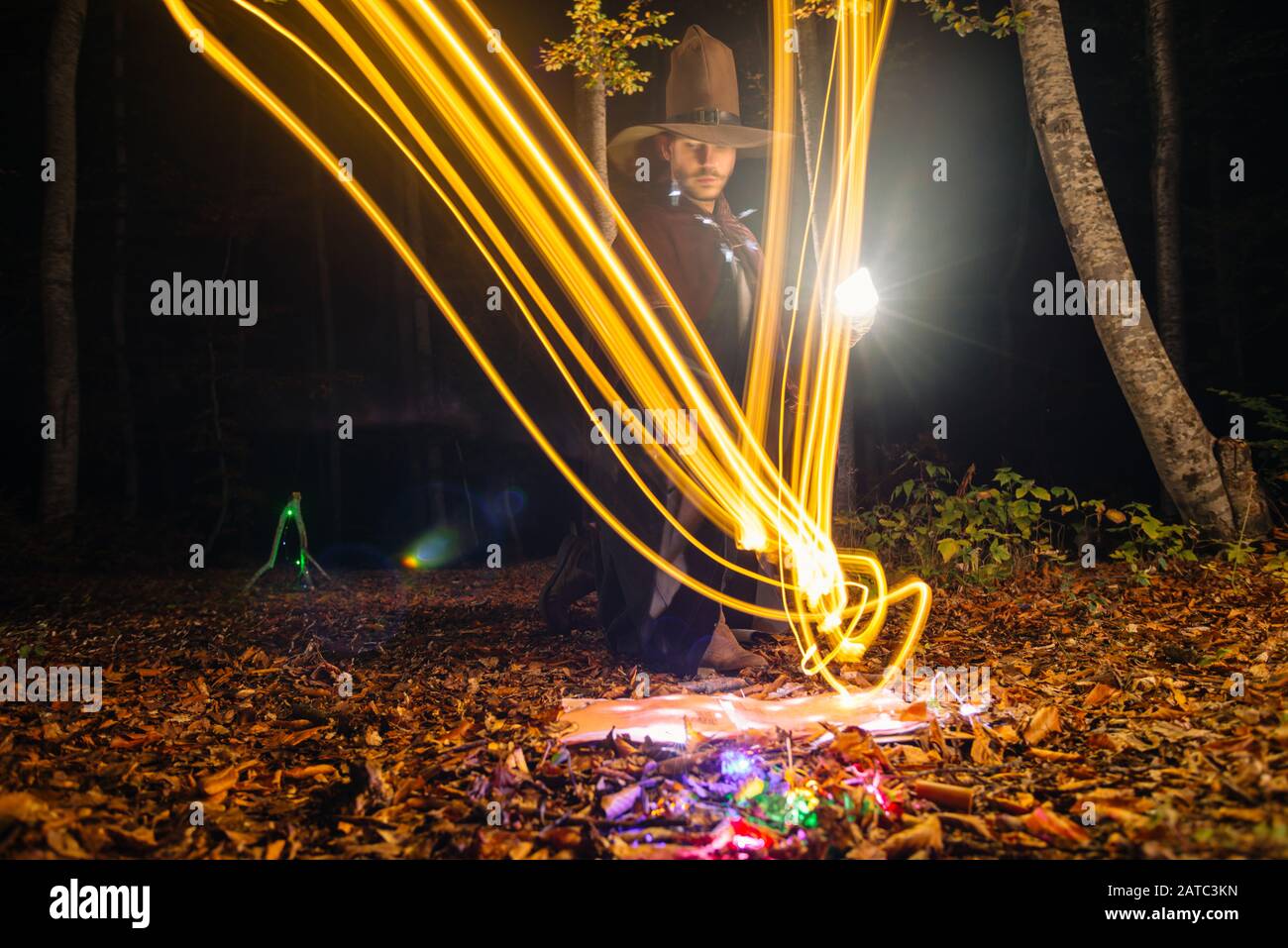 Wizard (mage) casting a spell with his magical staff while standing in ...
