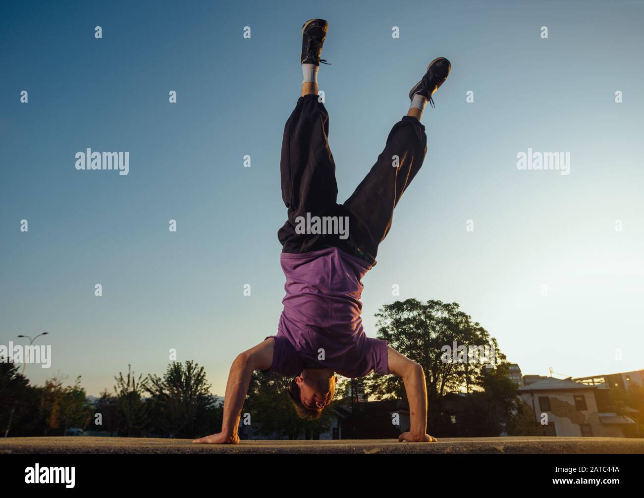 Muscular person performing a handstand in the city skateboard park ...
