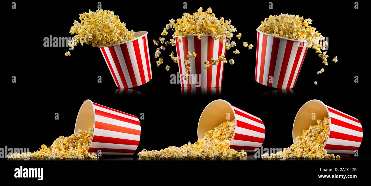 Set of paper striped buckets with scattered popcorn isolated on black ...
