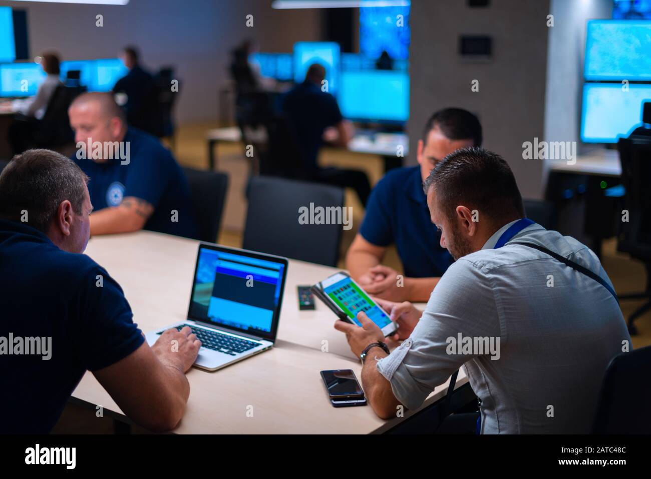 Group (security officers) tech guys meeting in a main security data ...