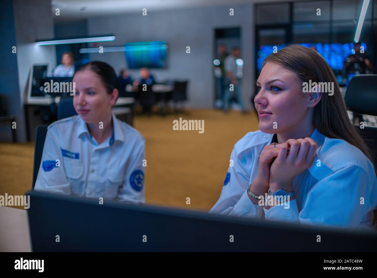 Close up photo of a security female agent monitoring the CCTV in a main ...
