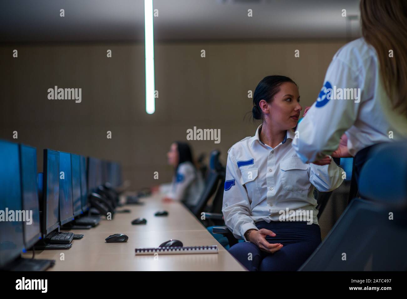 Security guard monitoring modern CCTV cameras in a surveillance room ...