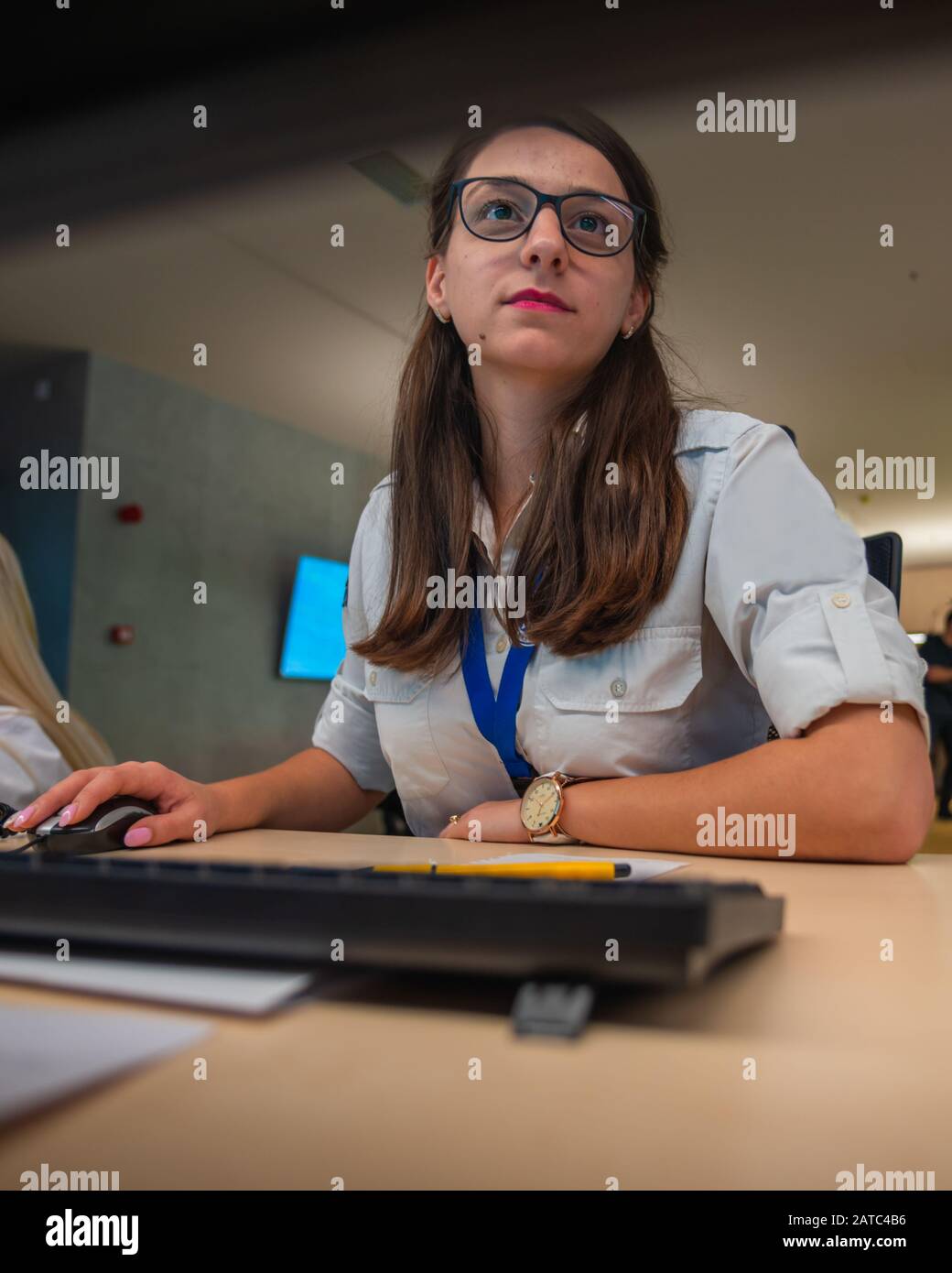 Female security guards working on computers while sitting in the main ...