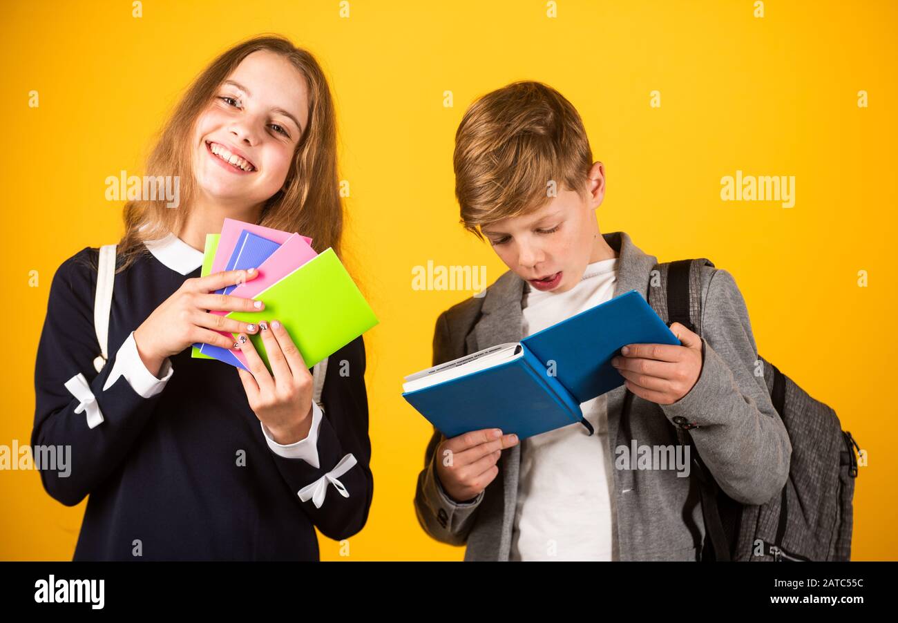 Exercise books ready for school ahead. Small children hold note books ...