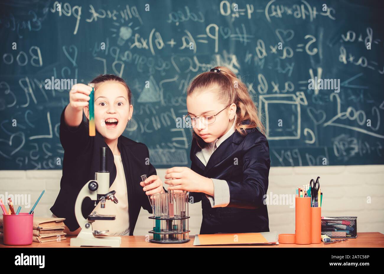 Girls school uniform busy with proving their hypothesis. School project ...