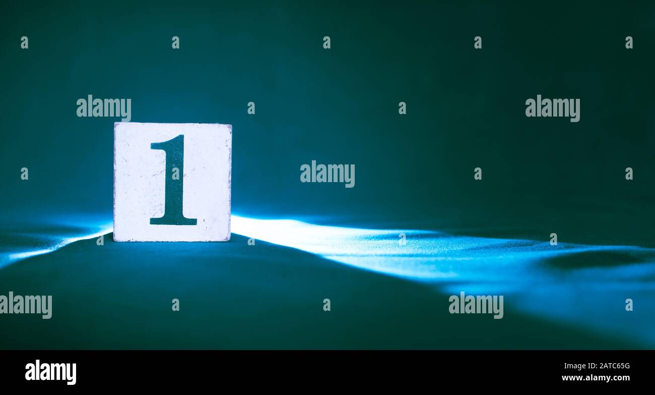 Block with number 1, one, on a dark blue background Stock Photo - Alamy