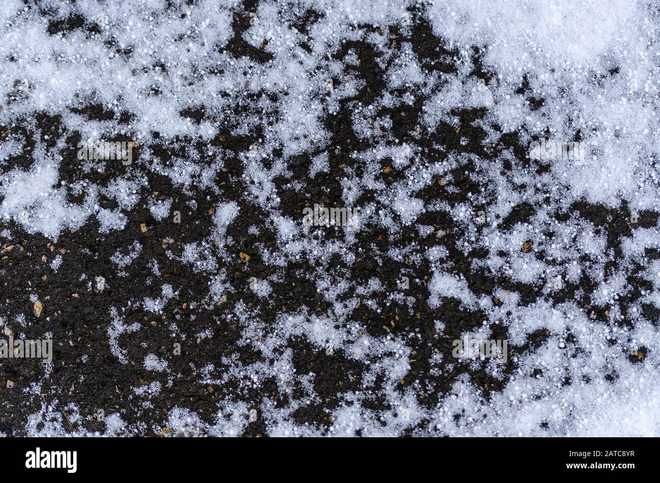 Texture of gray asphalt with melting snow in driveway. Concept of ...