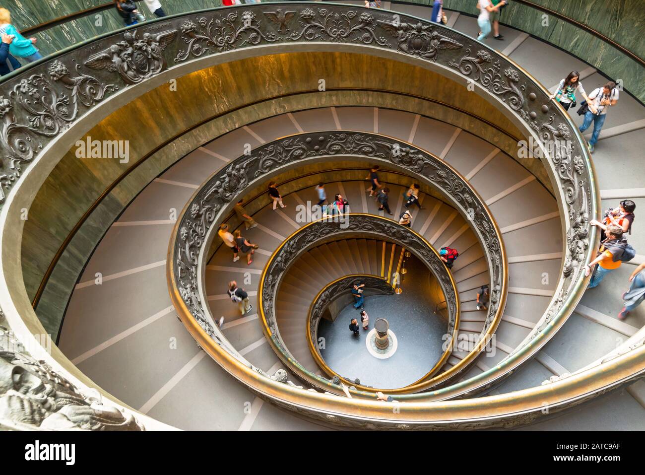 VATICAN - MAY 14, 2014: Tourists walk down the famous spiral staircase ...