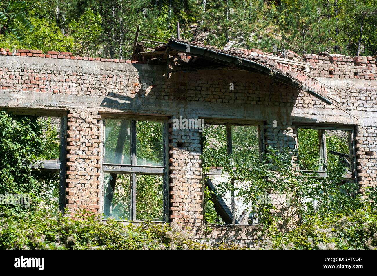 Old obsolete industrial building facade with broken windows Stock Photo ...