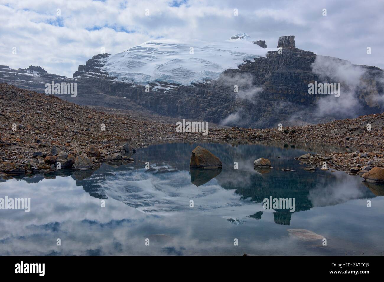 Pan de Azucar and Pulpito Del Diablo reflected in high altitude tarn ...
