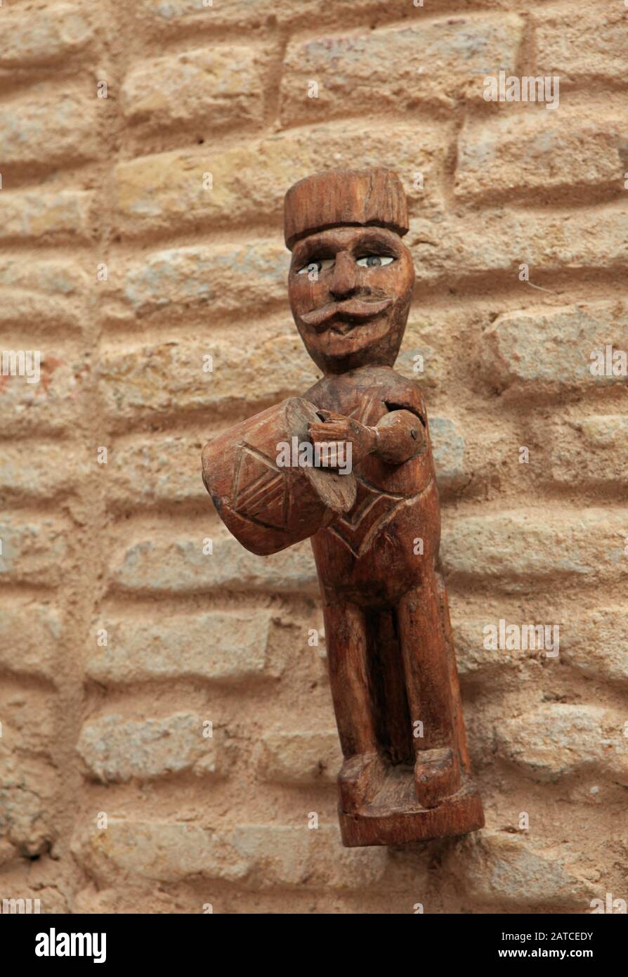 Local art. Miniature hand made statue for sale on the alley wall Stock ...