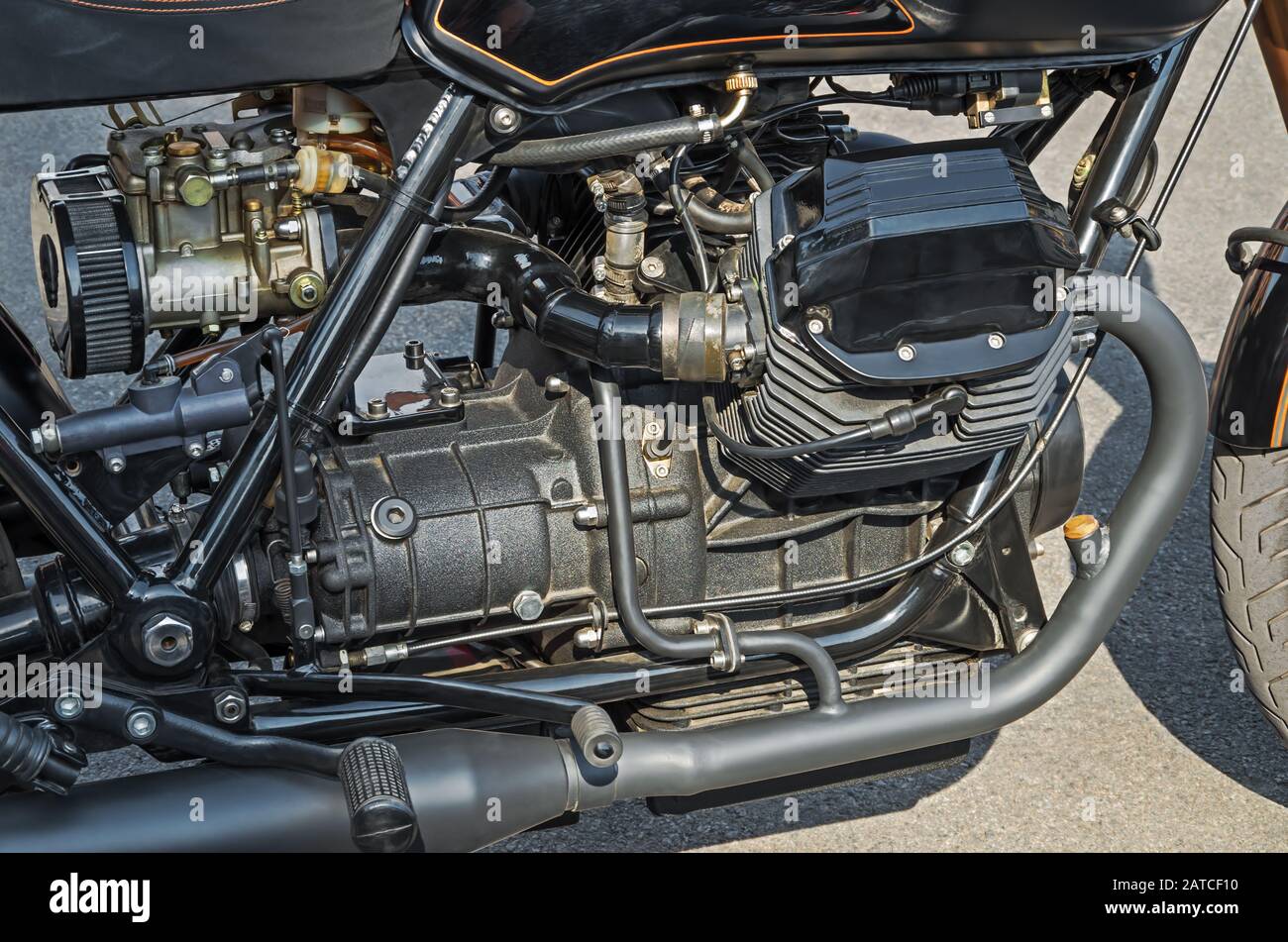 Two-cylinder motorcycle engine. Close-up depicts cylinder, gearbox and ...