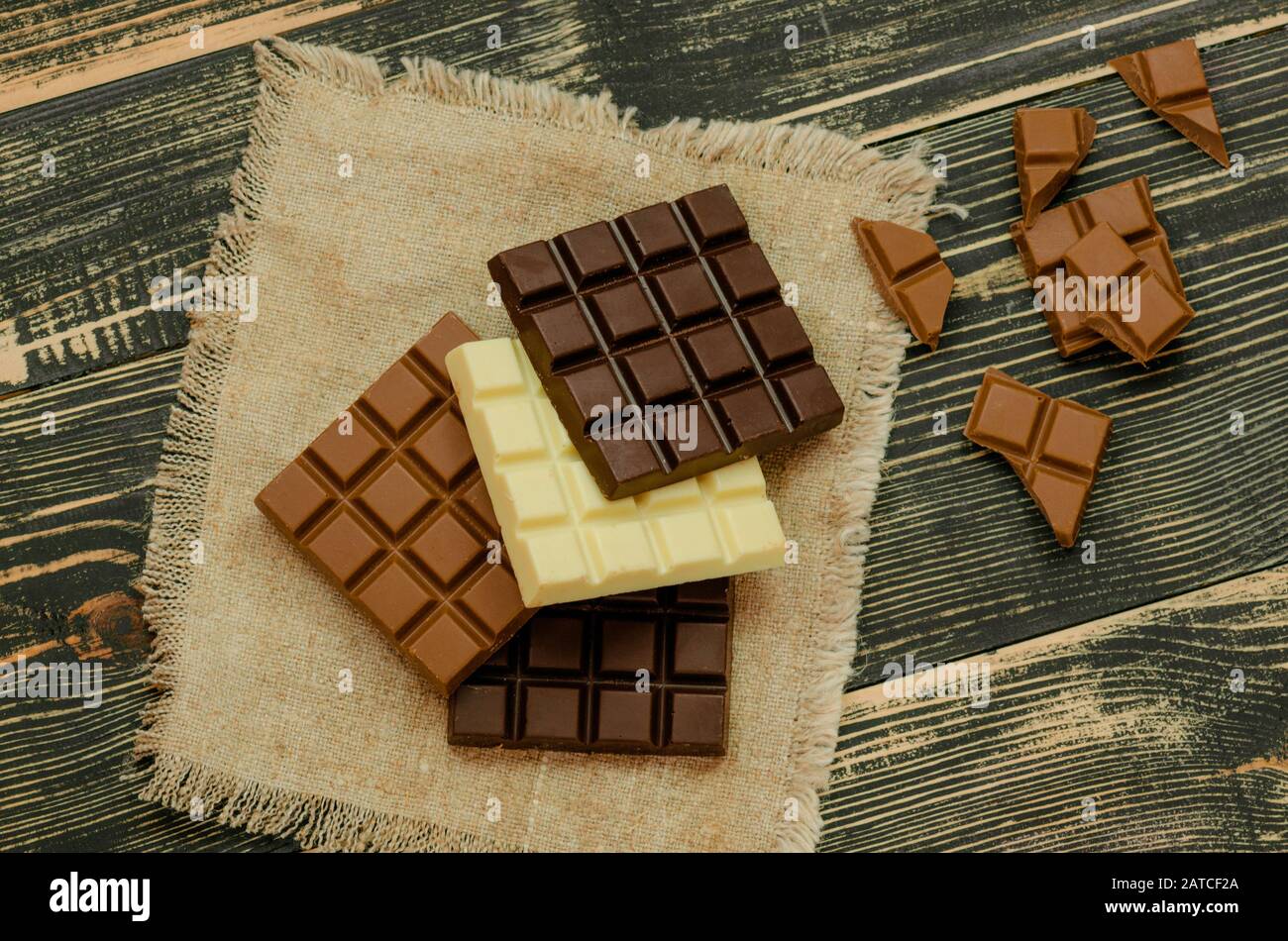 Dark, milk and white chocolate bars on wooden background Stock Photo ...