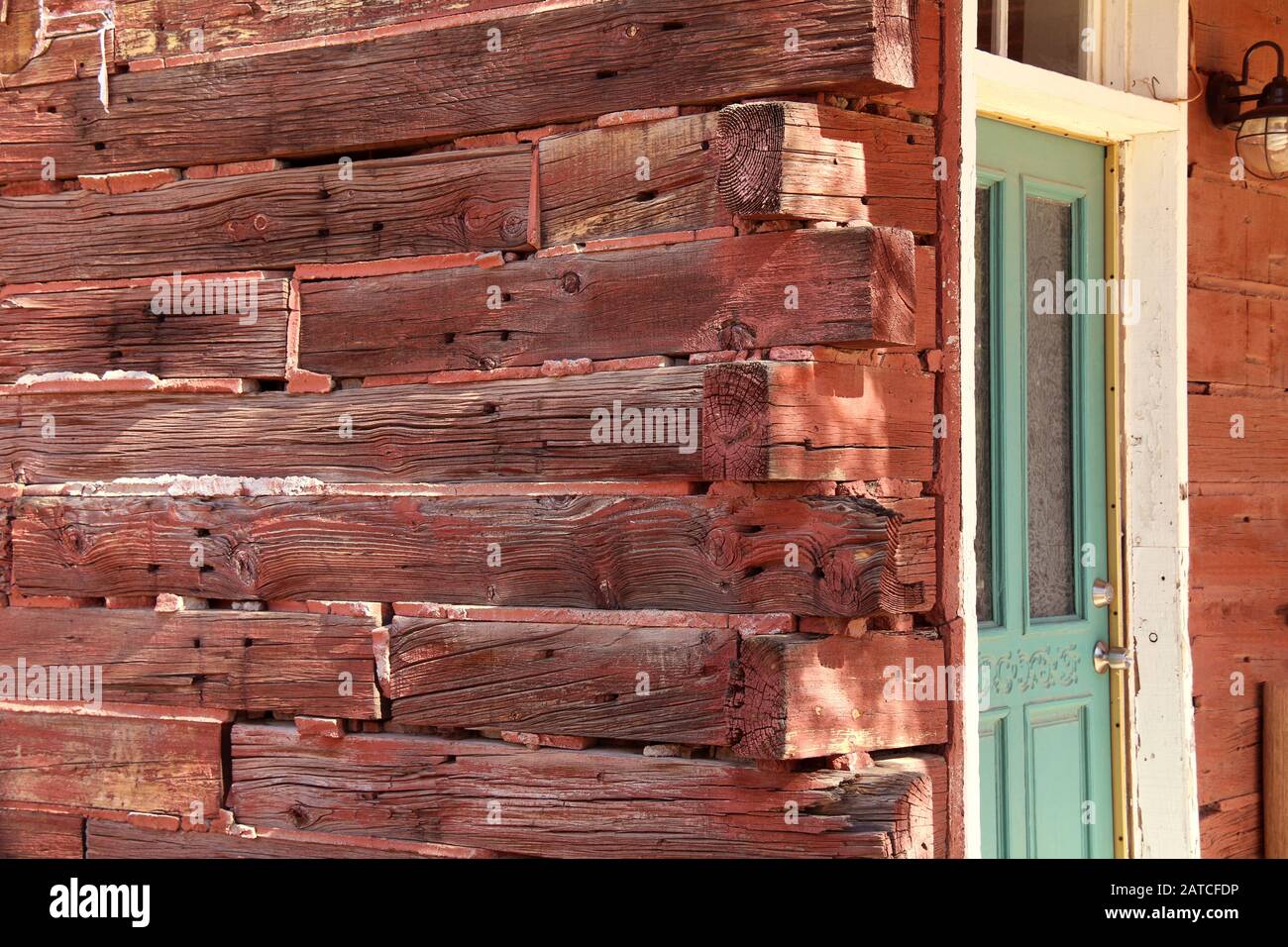 a red log cabin with green door Stock Photo - Alamy